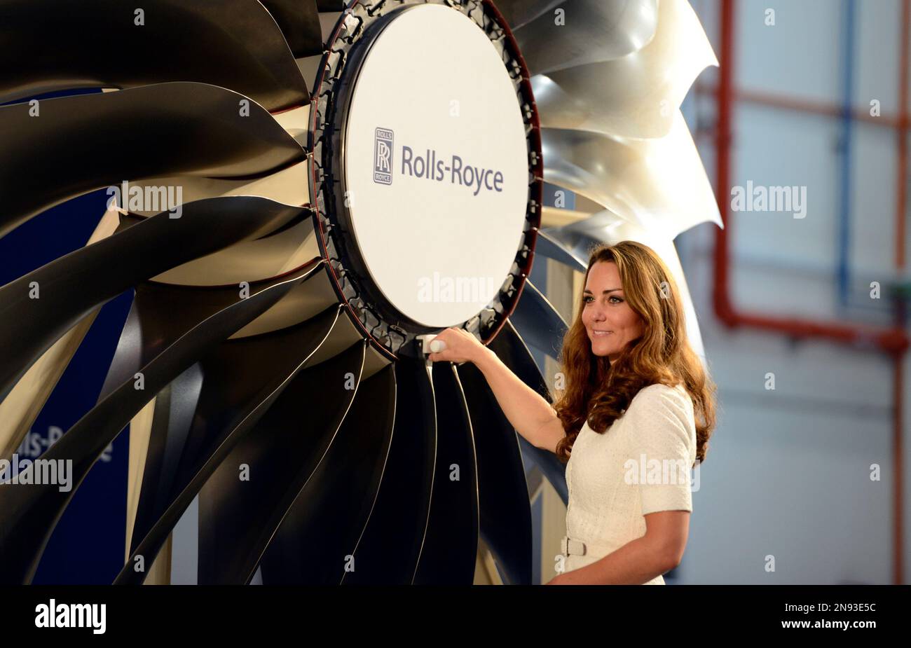 Kate, the Duchess of Cambridge prepares to push in the last blade of a ...