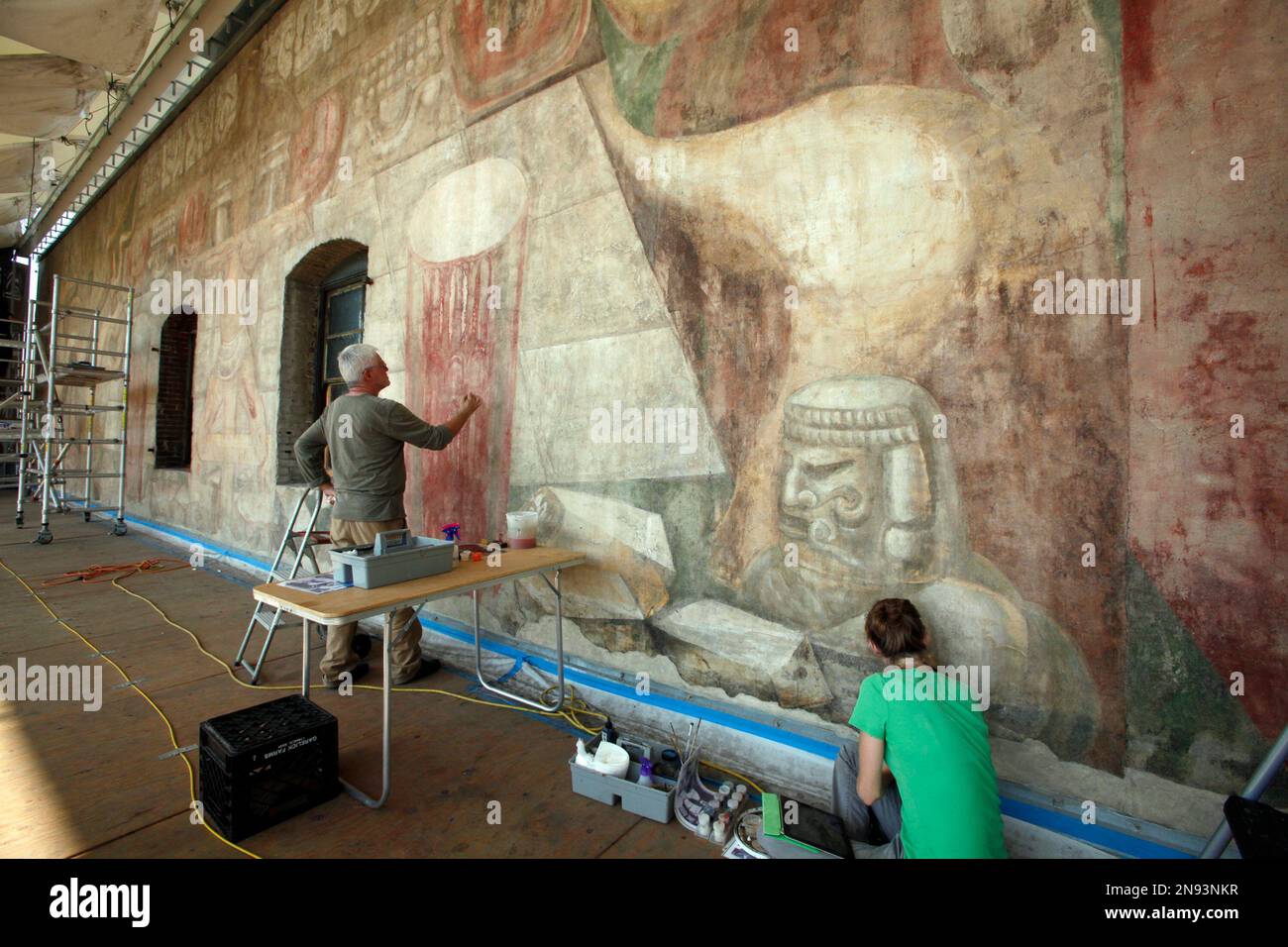 Art restorers work in the "America Tropical" mural, painted in 1932 by ...
