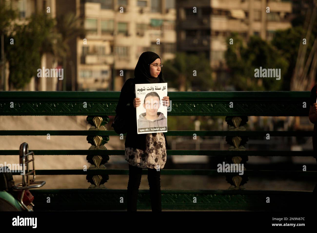 A young Egyptian woman holds a picture of Khaled Said during a silent ...
