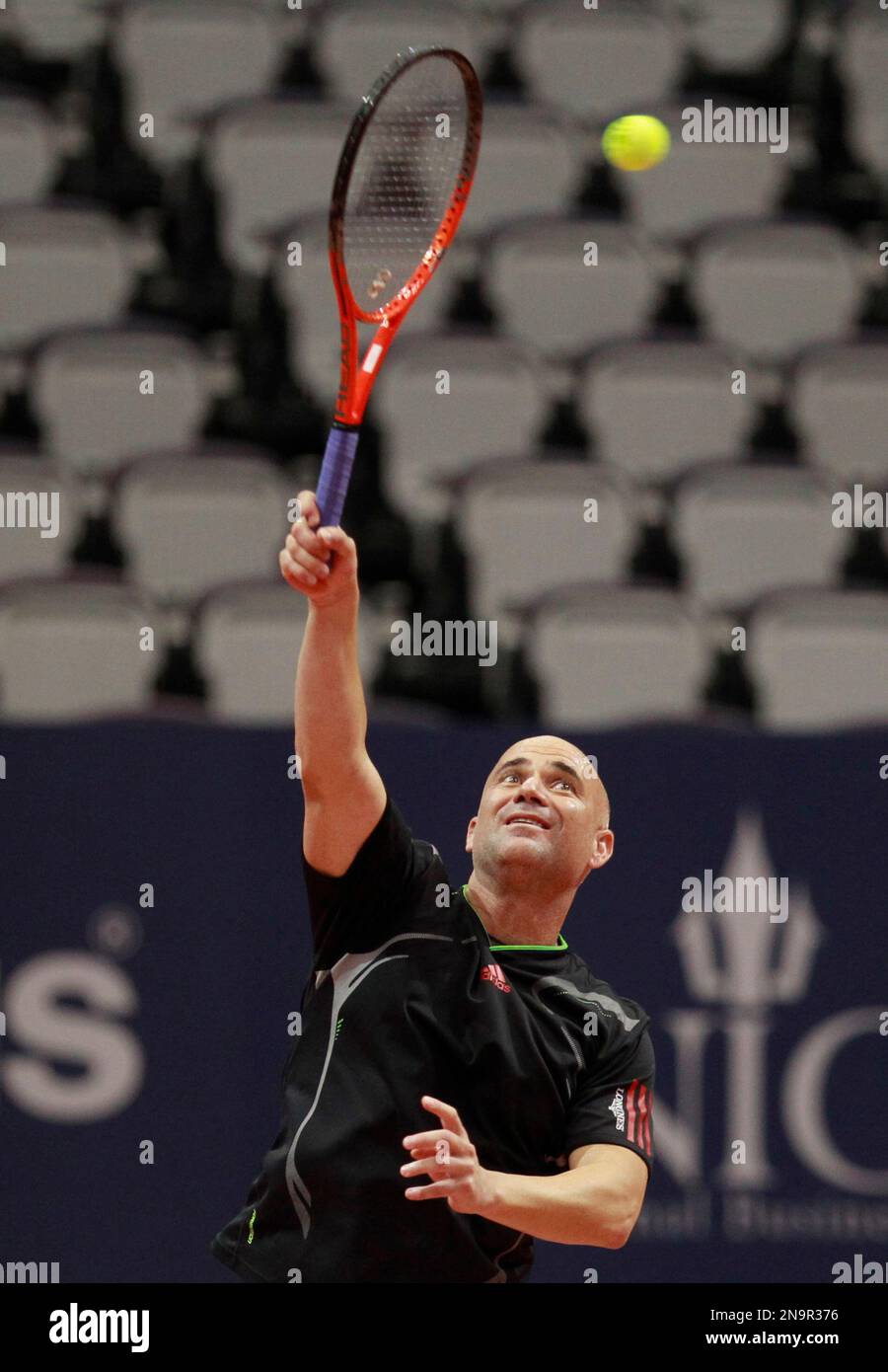 Former tennis star Andre Agassi returns a serve during a "Rise of ...