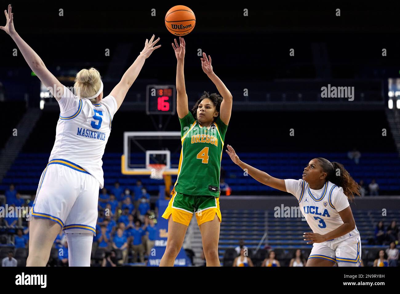 Oregon guard Endyia Rogers, center, shoots as UCLA forward Brynn ...