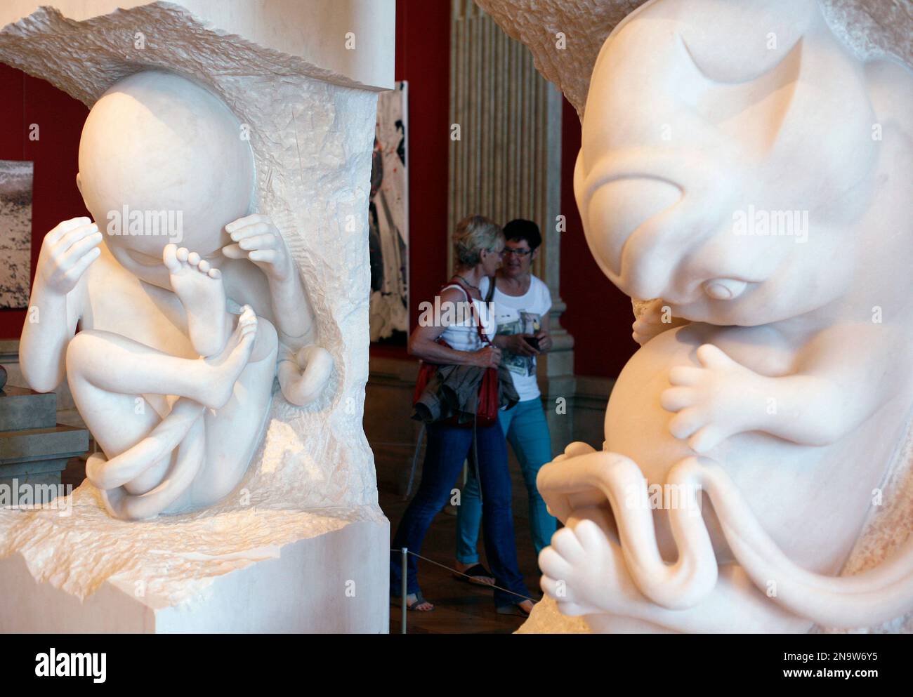 Visitors walk past the British artist Marc Quinn's work "Evolution", at ...