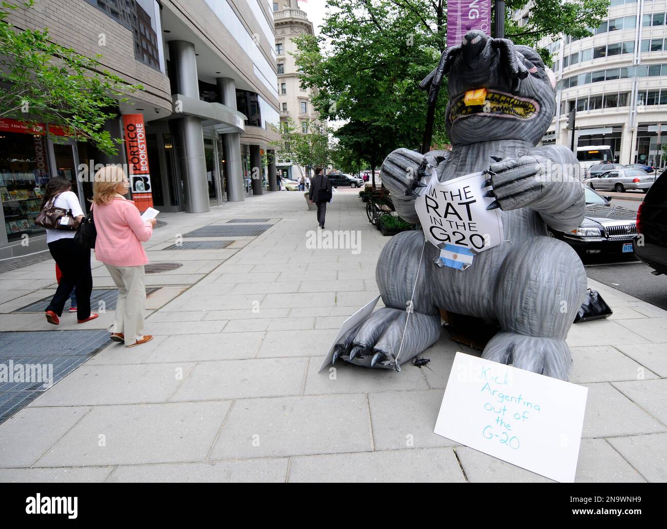 A large inflatable rat stands near the Inter-American Development Bank ...