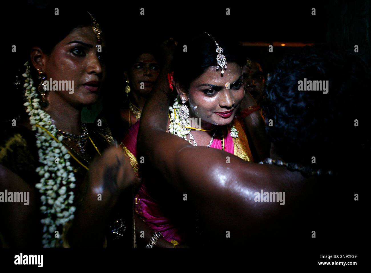 In this Tuesday, May 1, 2012 photo, a temple priest ties a "Thali", a ...