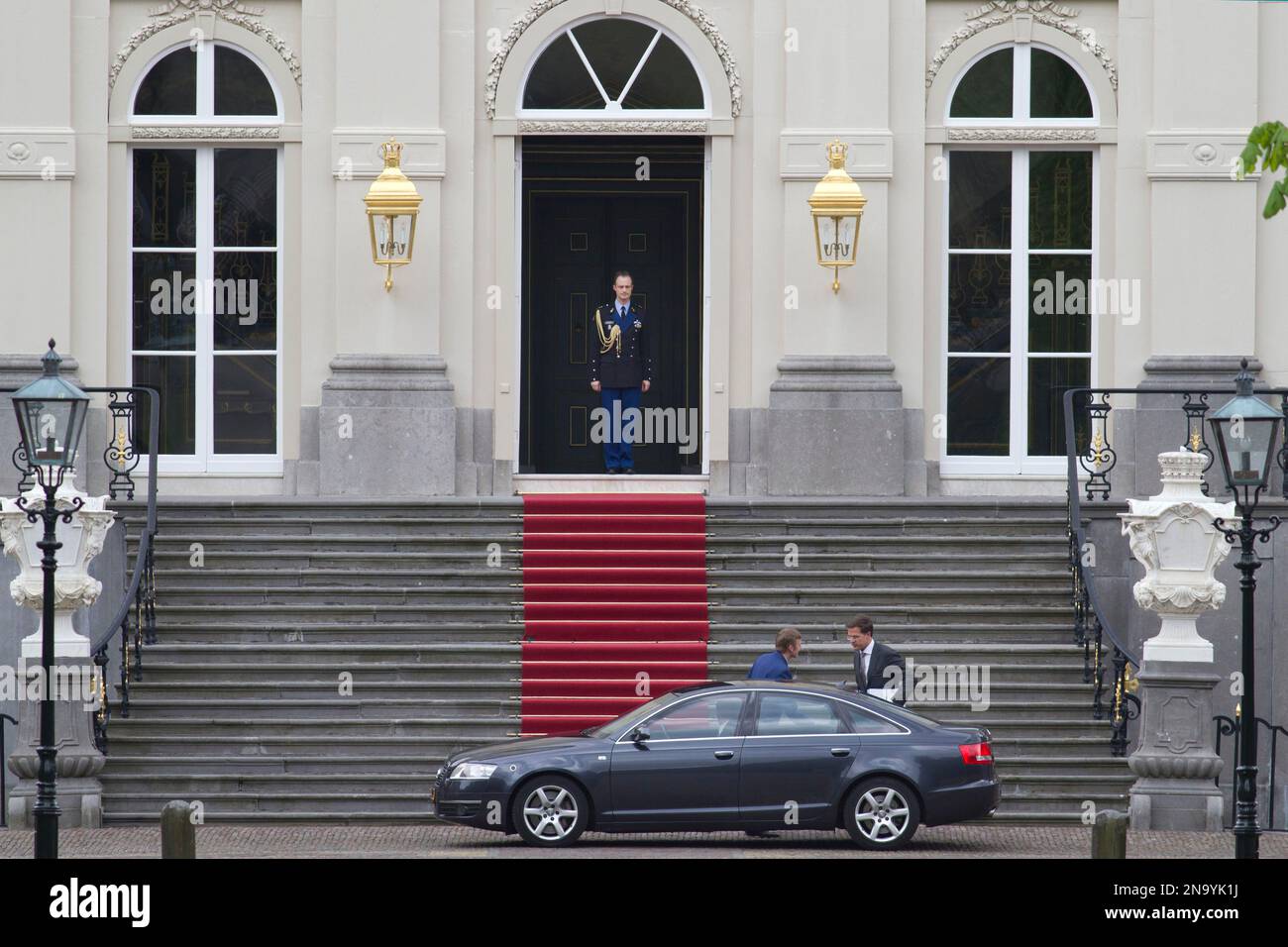Dutch prime minister Mark Rutte, bottom right, gets into his car as he ...