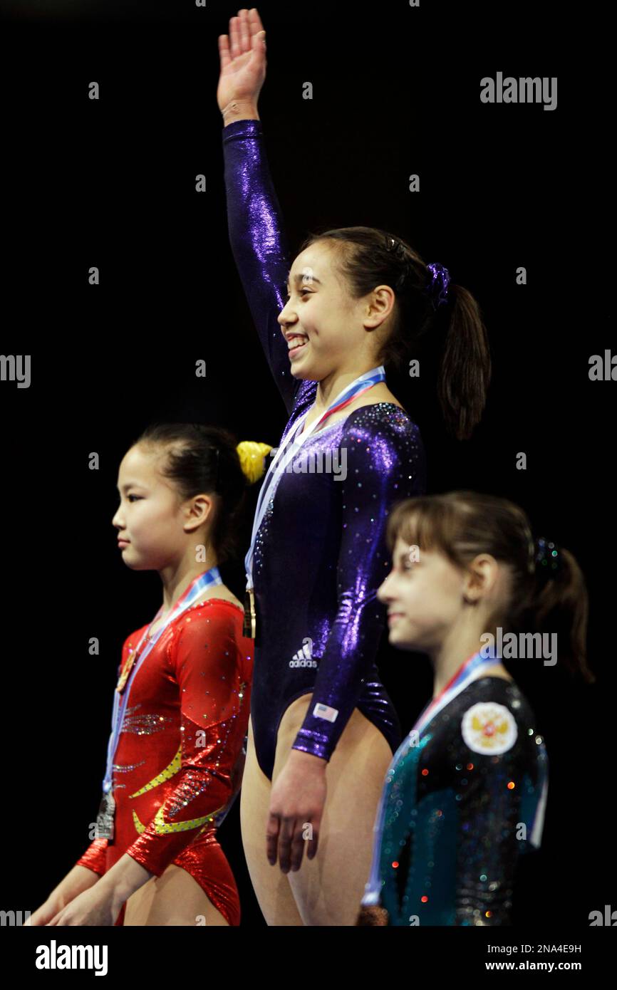 Katelyn Ohashi, center, waves after she was awarded the gold medal for ...