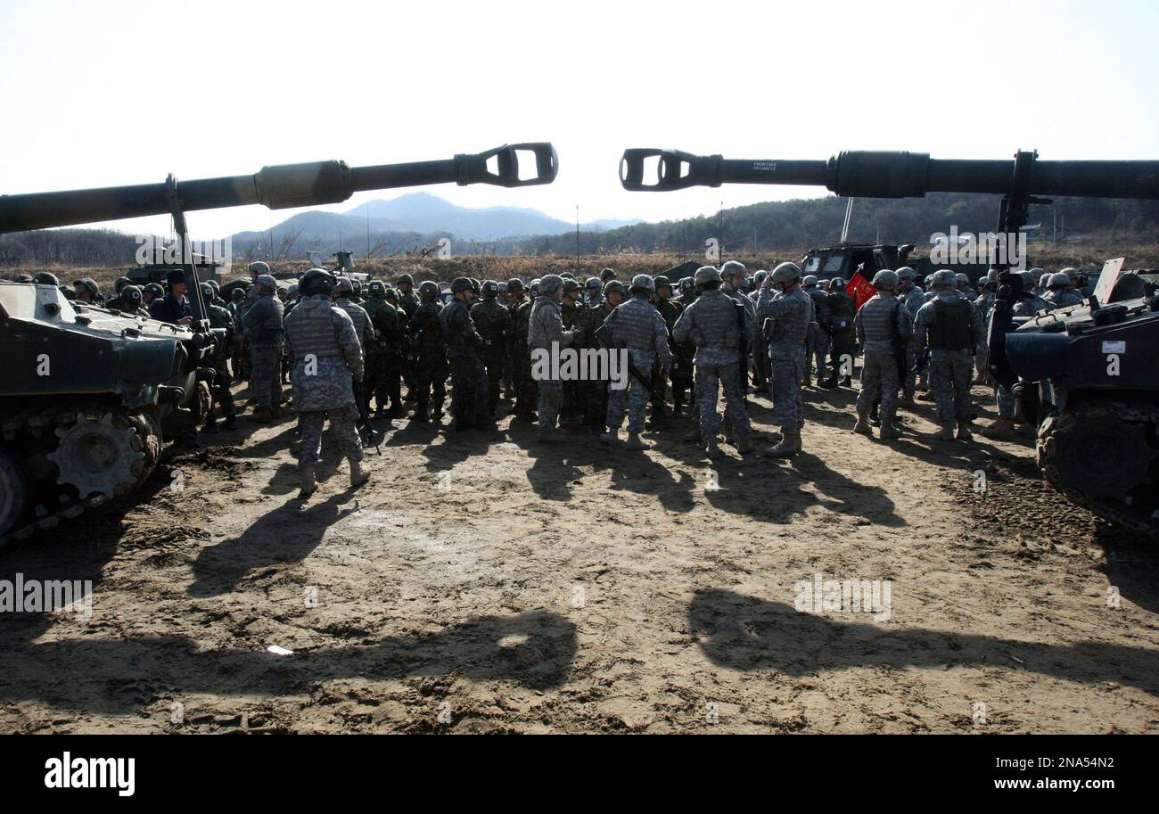 South Korean and U.S. army soldiers, gray, pose after a live fire drill ...