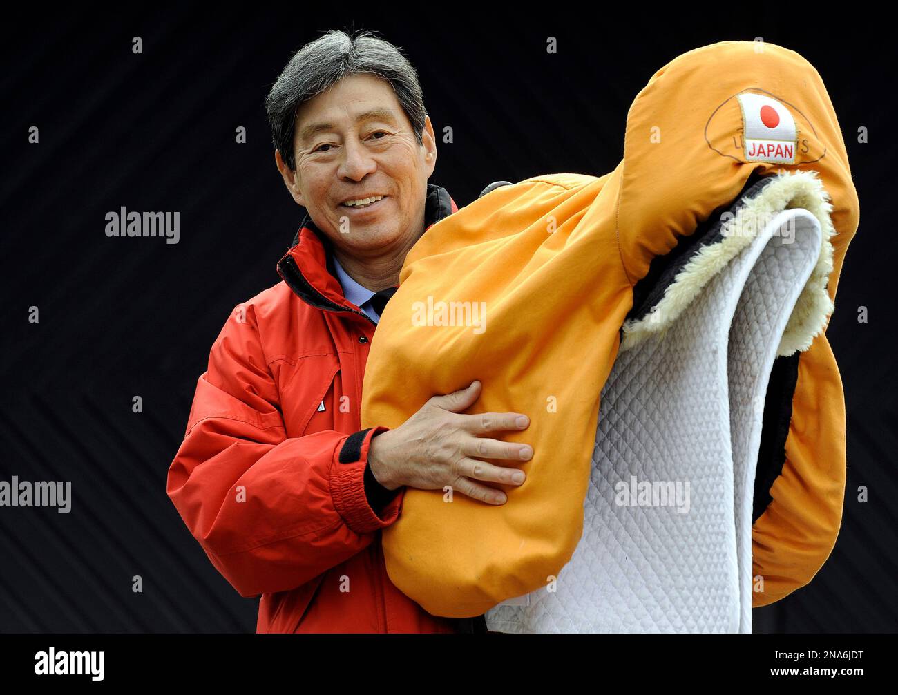 Japan's oldest Olympian Hiroshi Hoketsu carries a saddle at a horse ...