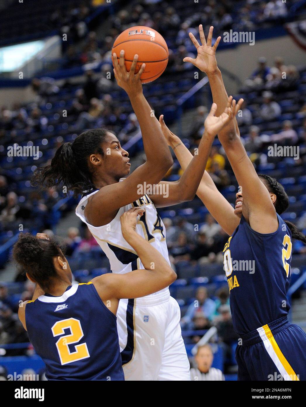 Notre Dame's Devereaux Peters, center, shoots while being guarded by ...