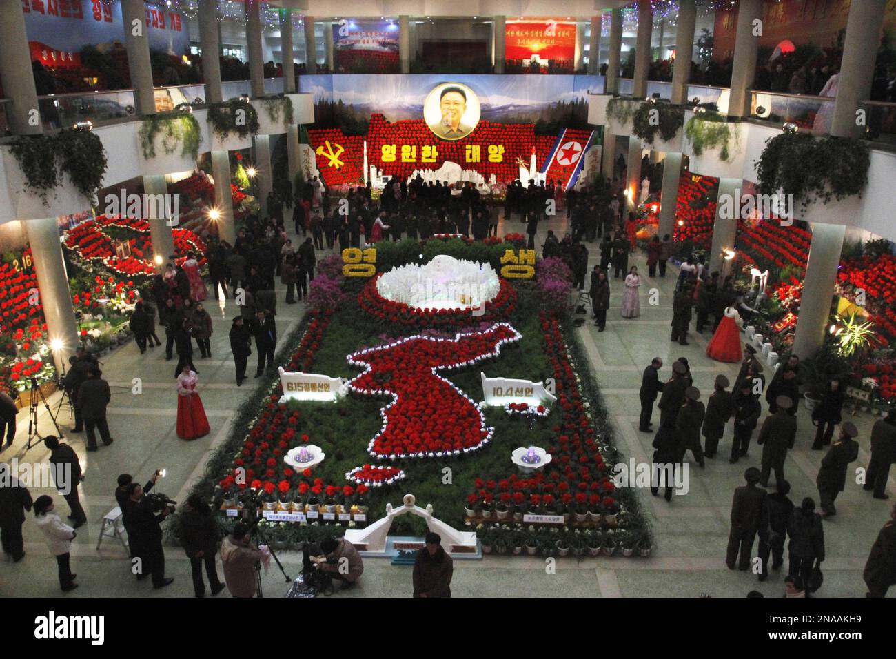 People walk through an exhibition of flower arrangements of the ...