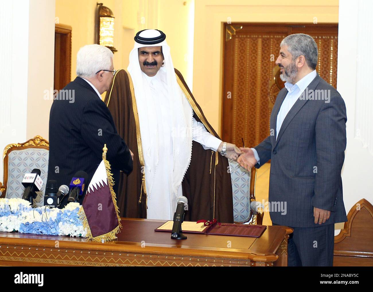 Emir of Qatar Sheikh Hamad Bin Khalifa Al-Thani, center, and Palestinian President Mahmoud Abbas ...
