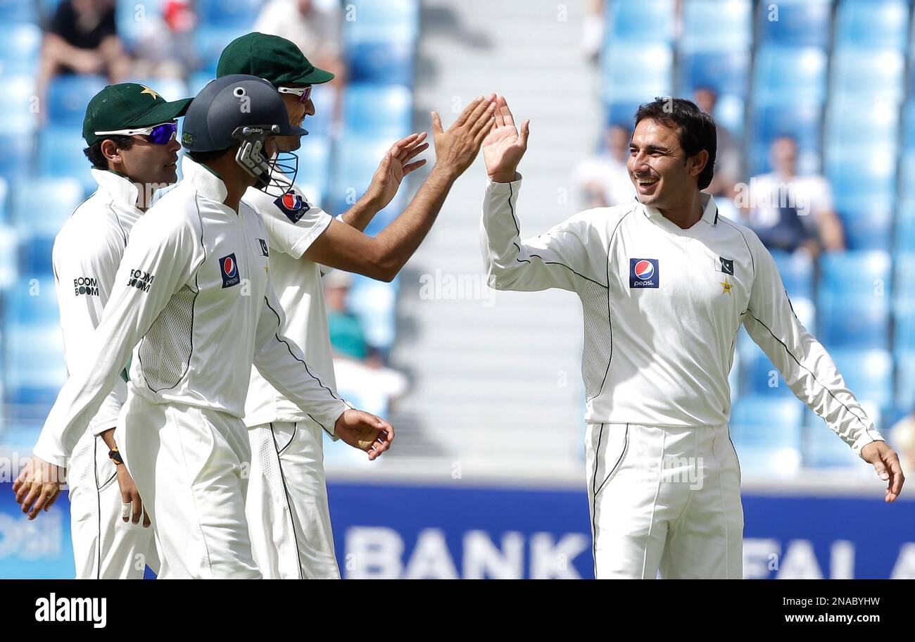 Pakistan's bowler Saeed Ajmal, right, celebrates with his teammates ...