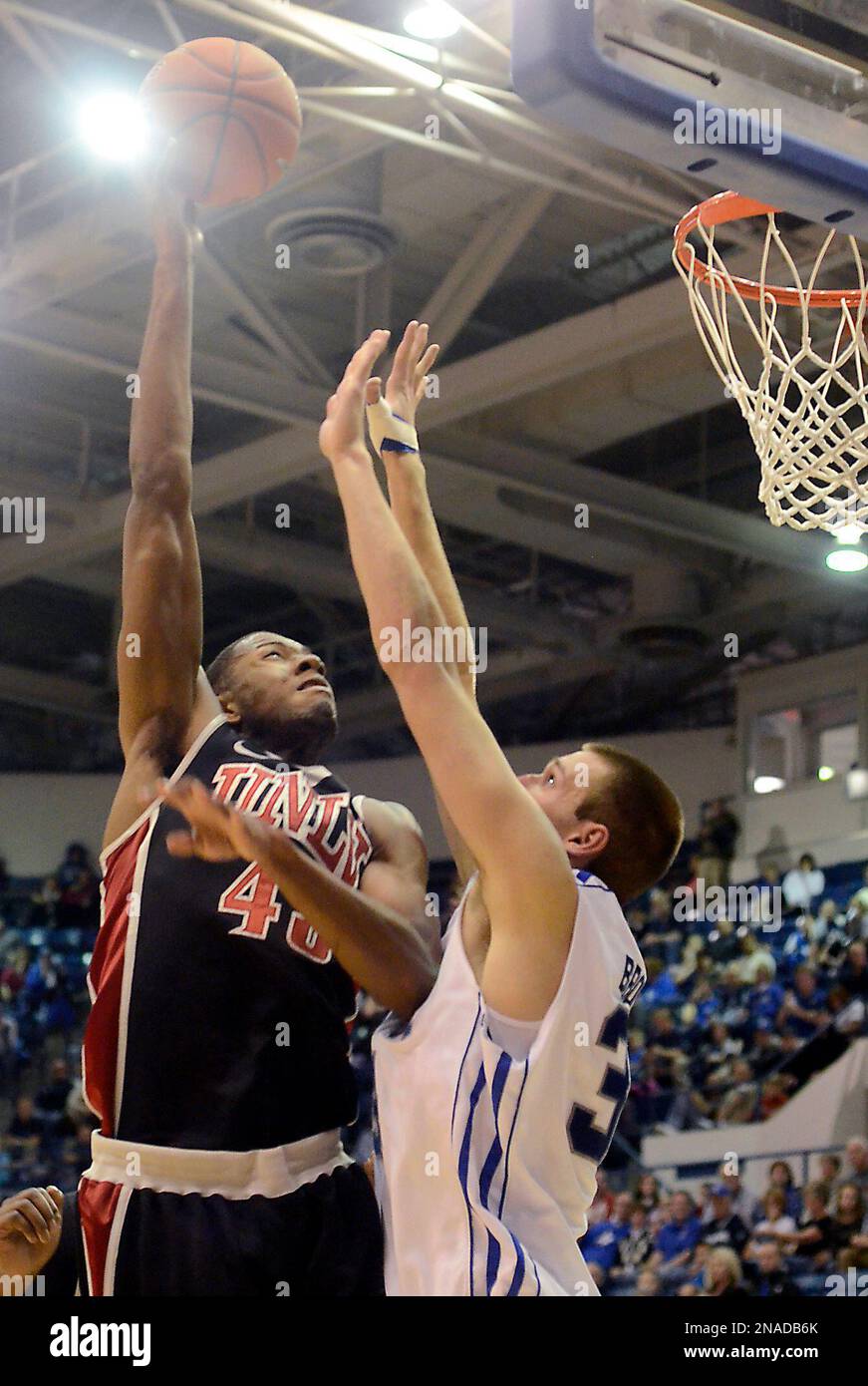 Mike Moser, left, of UNLV takes a shot over Air Force center Taylor ...