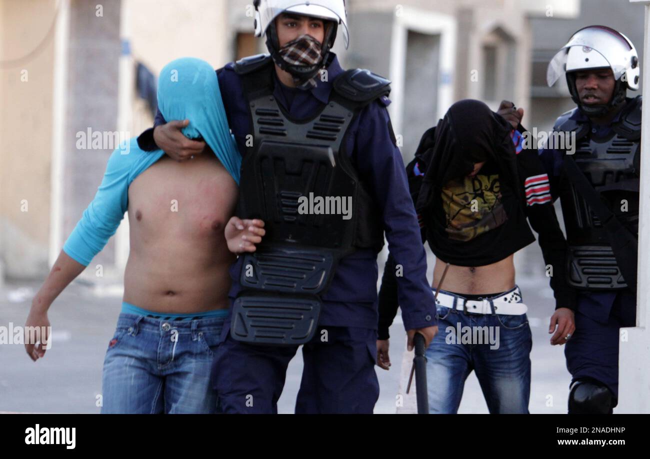 Riot police arrest Bahraini anti-government protesters during heavy ...