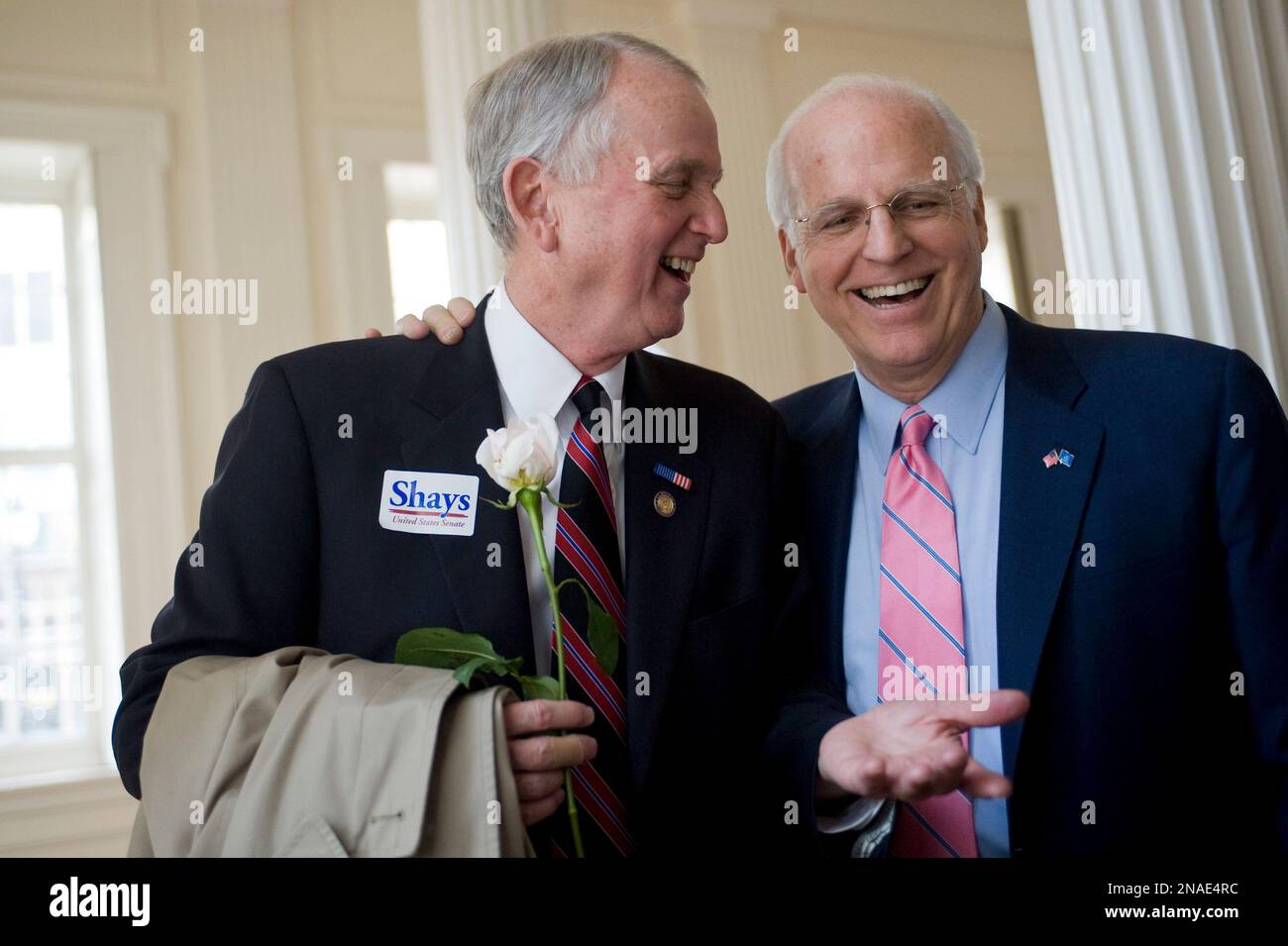 Former Connecticut U.S. Rep. Christopher Shays, right, shares a light ...