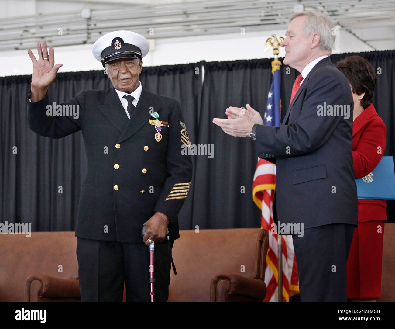 Carl Clark, 95, left, waves after being presented the prestigious Navy ...