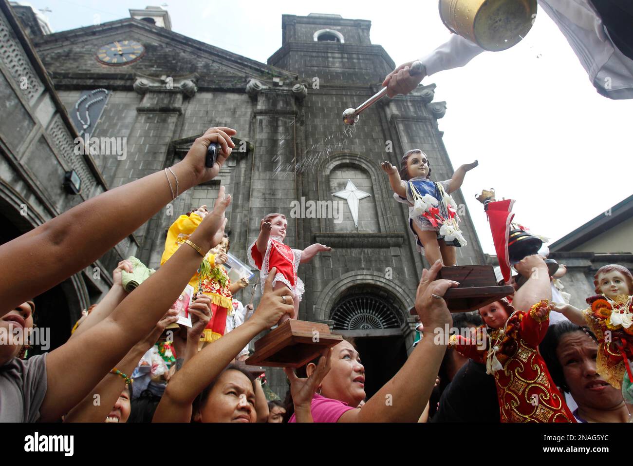 Roman Catholic devotees raise statues of the Holy Child Jesus for ...
