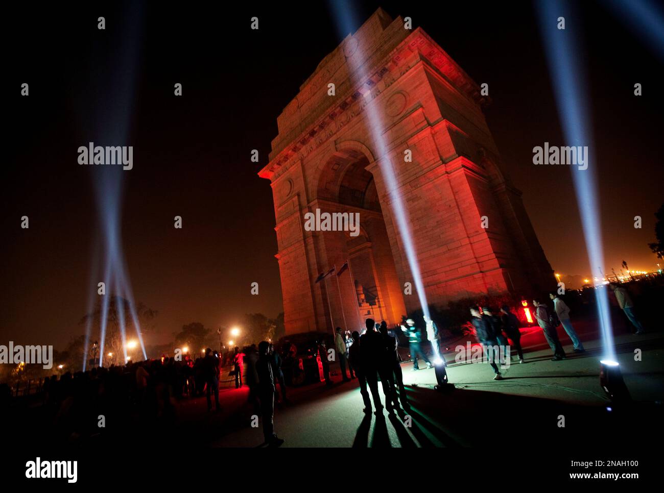 Indians watch a laser light show on the India Gate Monument as part of ...
