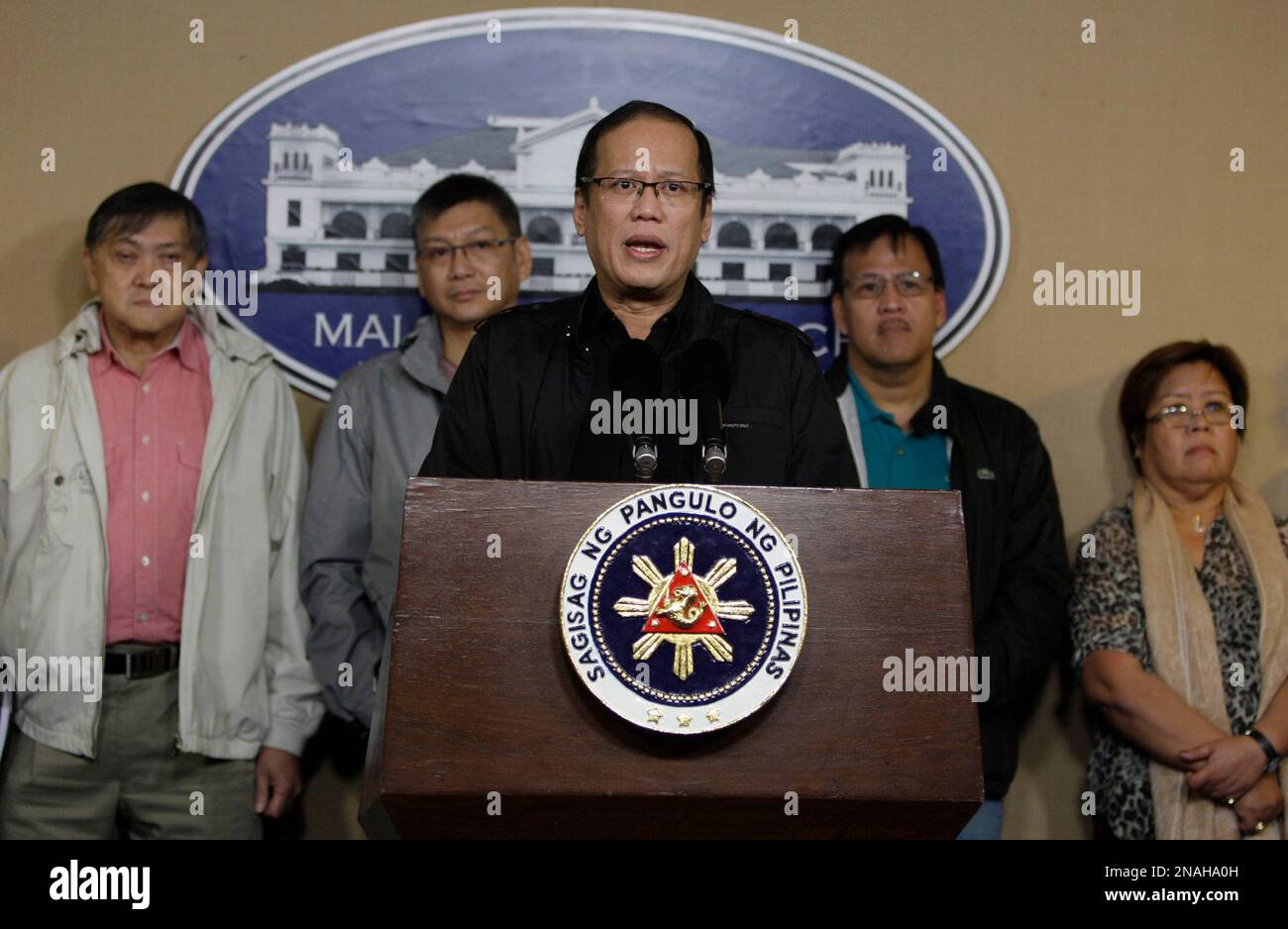 Philippine President Benigno Aquino III, center, talks beside cabinet ...