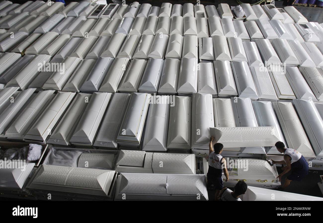 Philippine Navy personnel arrange coffins that will be shipped with ...