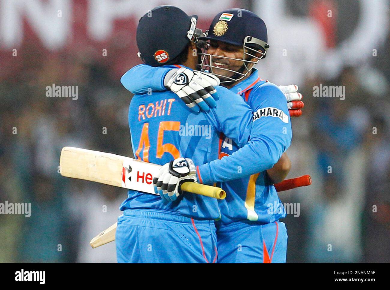 India's batsman Rohit Sharma, left, hugs captain Virender Sehwag to ...