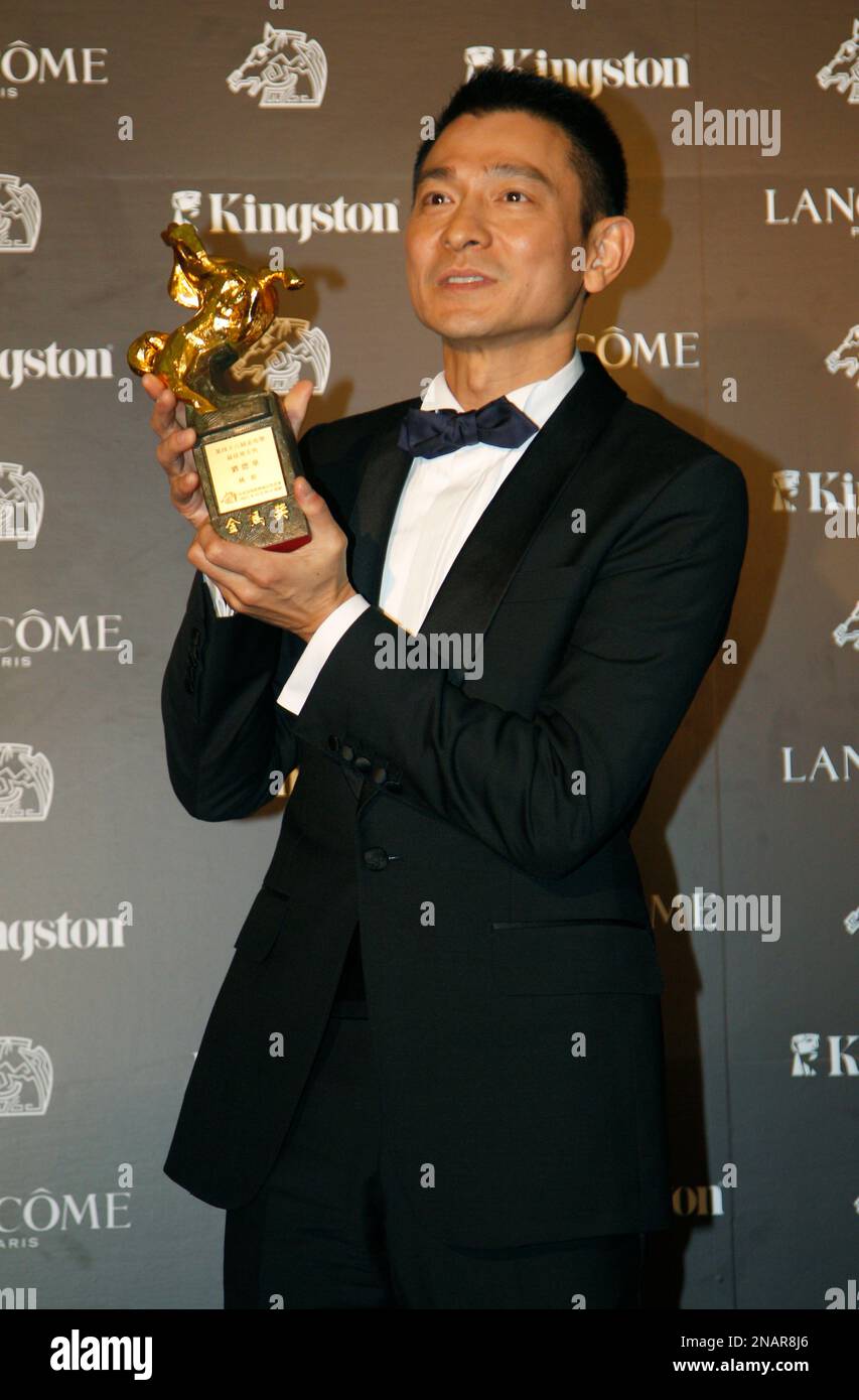 Hong Kong actor Andy Lau holds his awards for Best Leading Actor at the ...