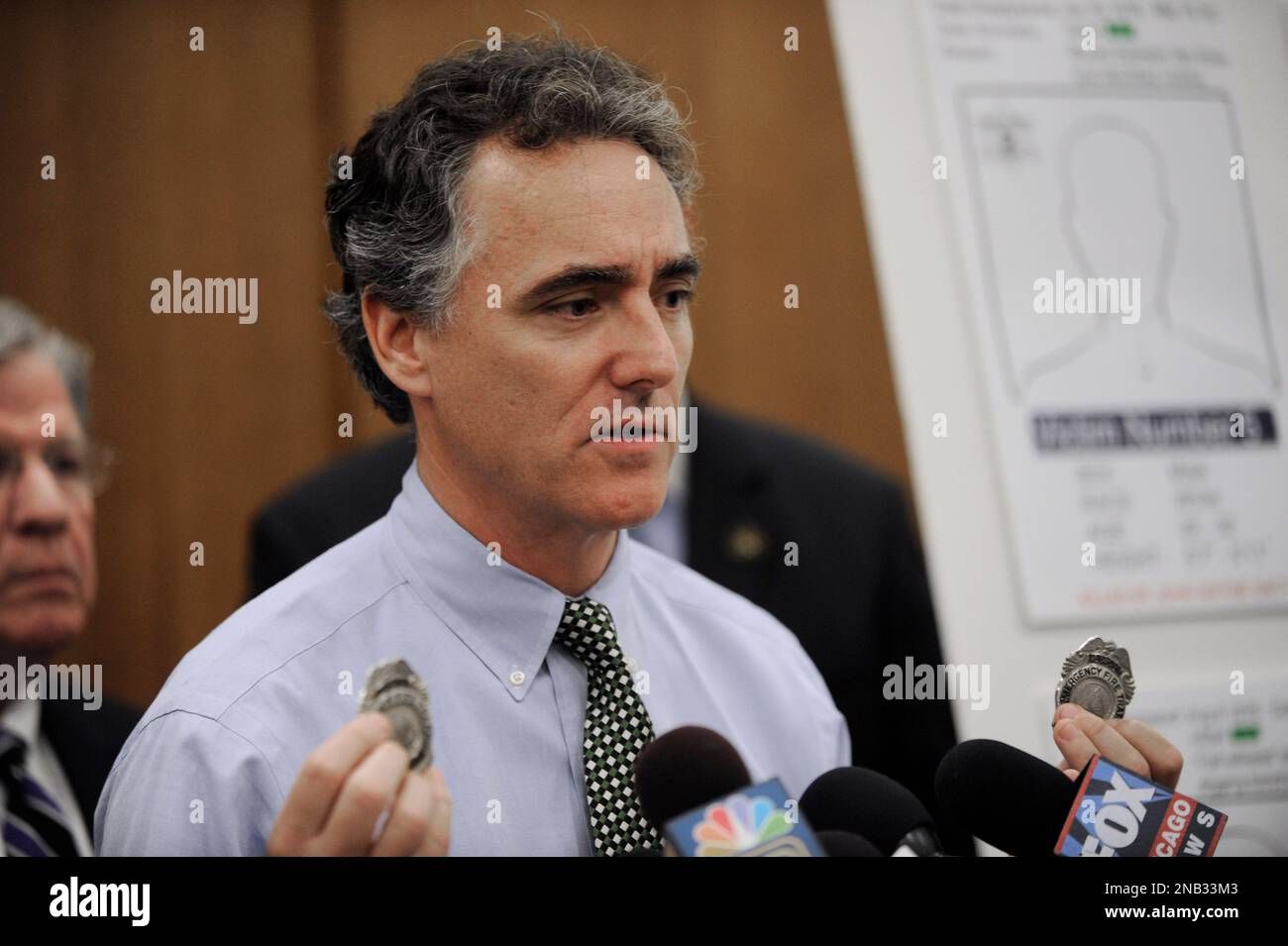 Cook County Sheriff Tom Dart holds up police badges used by serial ...