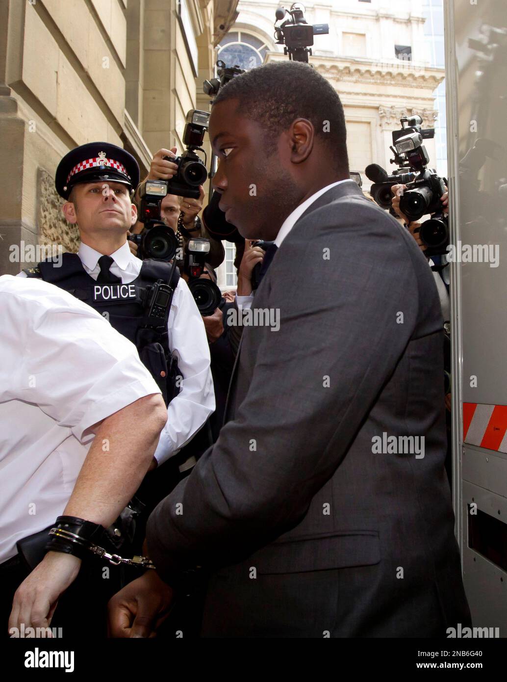 Alleged renegade UBS trader Kweku Adoboli is led from a security van as ...