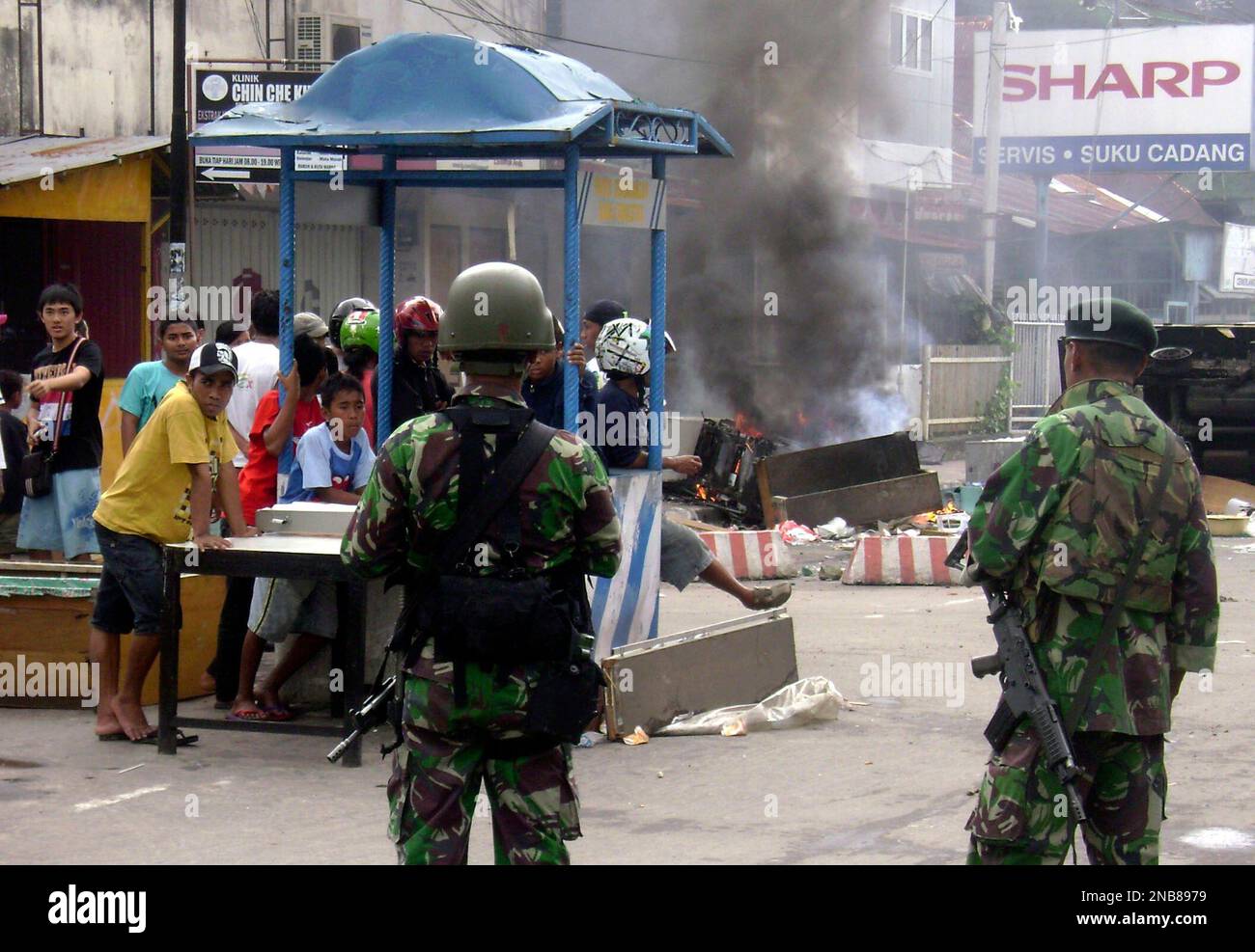 Indonesian soldiers stand guard on a street in Ambon, Maluku province ...