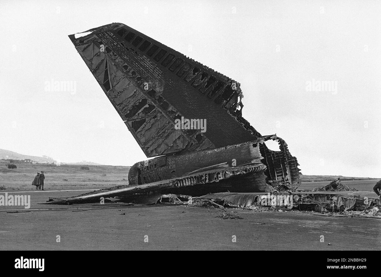 The burnt out tail section of the KLM jumbo jet lies on runway at Los ...