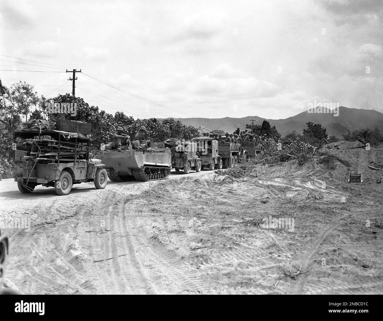 U.S. Marines of the 6th Marine Division shown on trucks coming out of ...