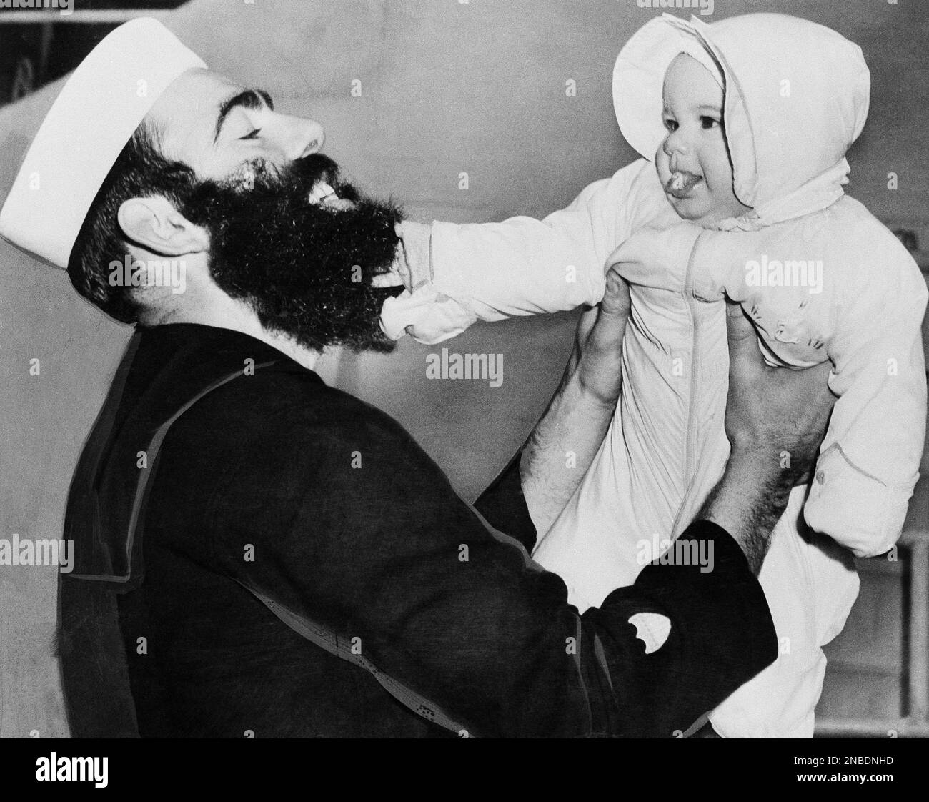 Five-month-old Tamera Larson tugs at the beard sported by her dad ...