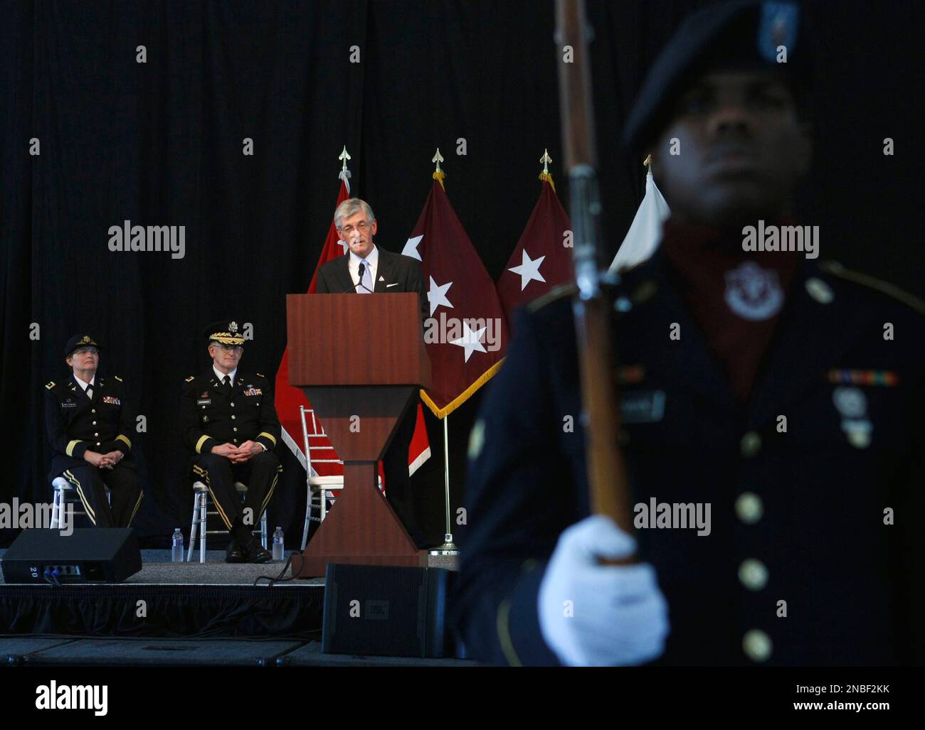 Army Secretary John McHugh, at podium, speaks as, from left, Army Maj ...