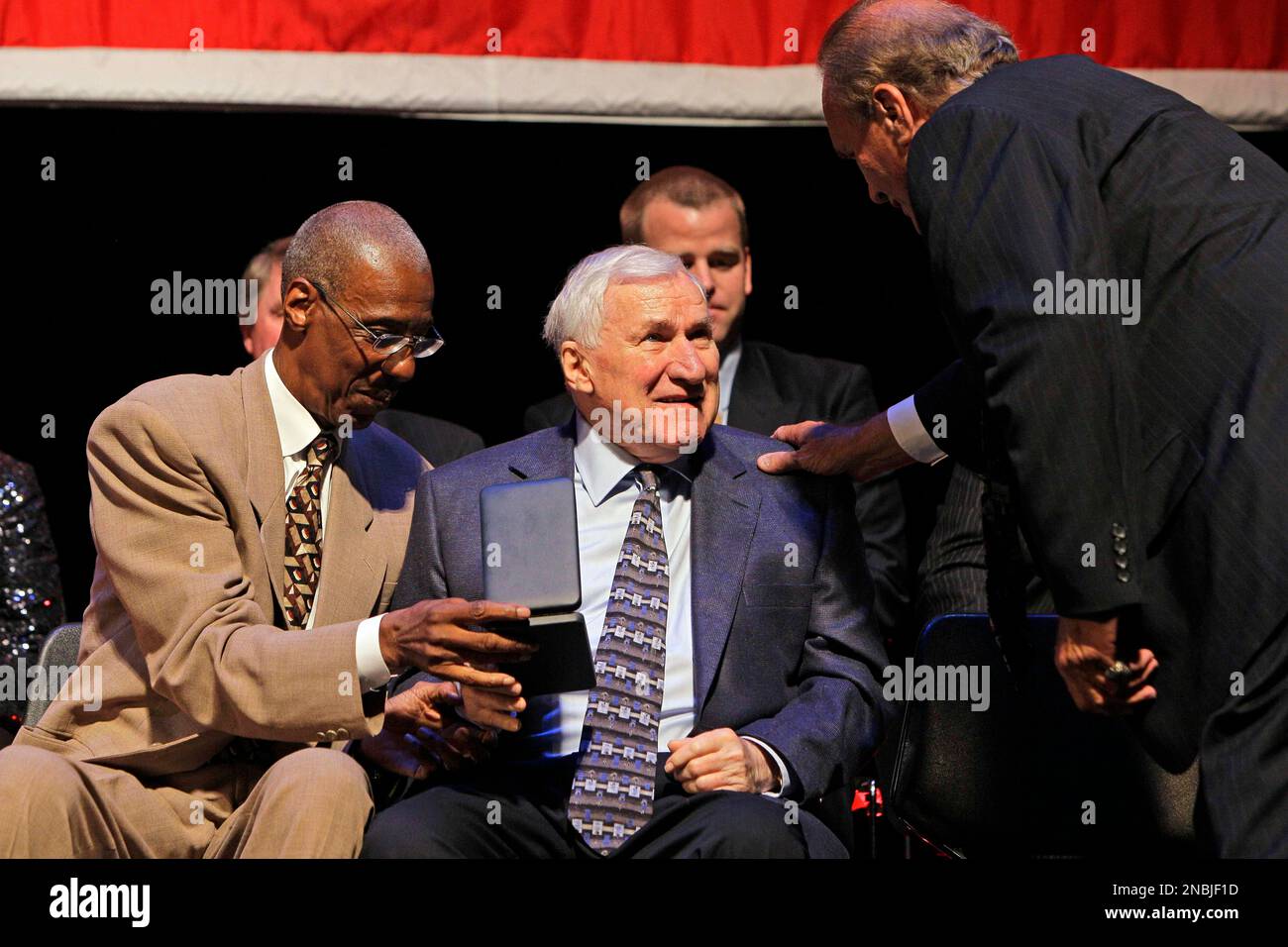 Former North Carolina basketball coach Dean Smith, center, is presented ...