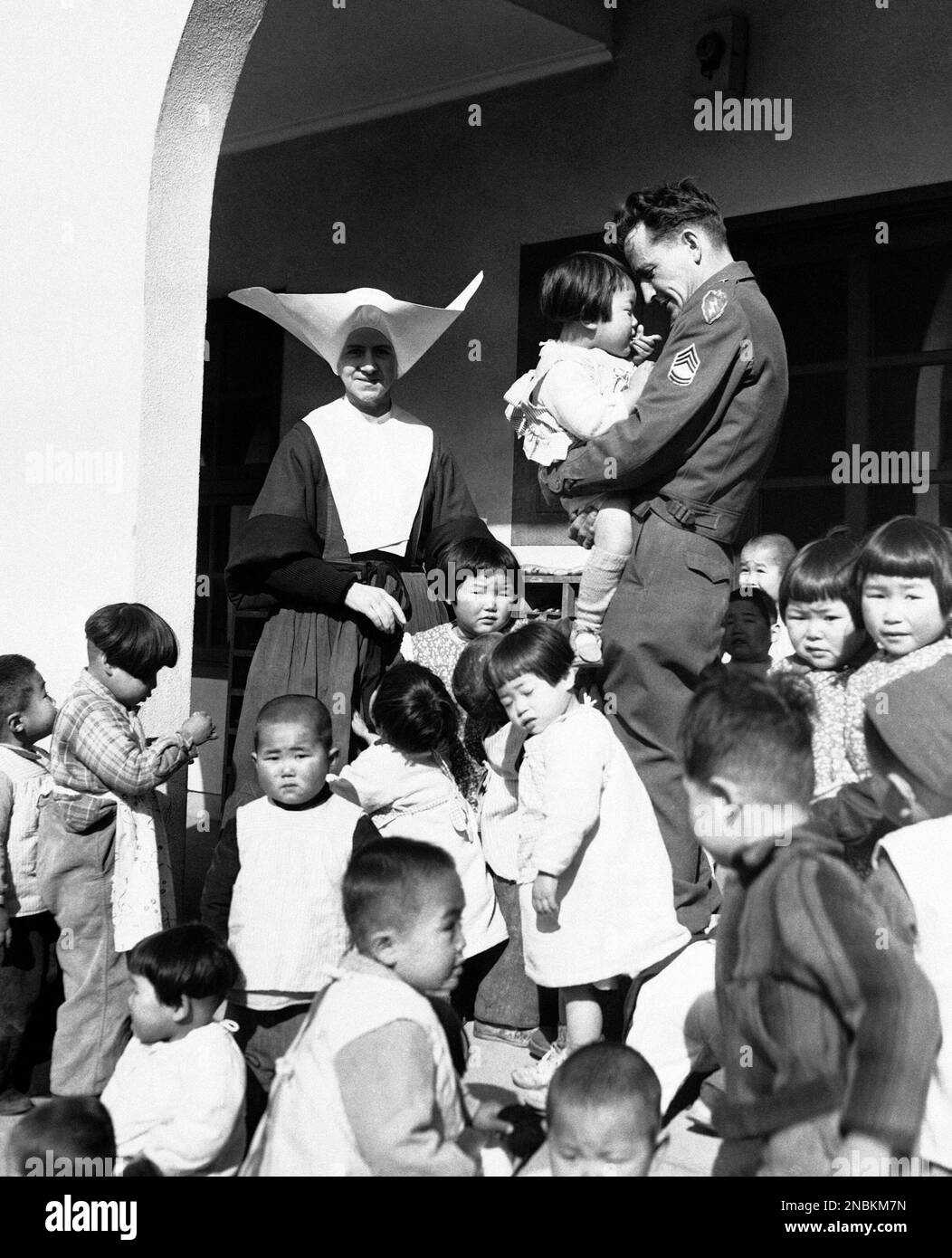 A little Japanese orphan welcomes Sgt. Hugh O’Reilly, Bronx, N.Y., as ...