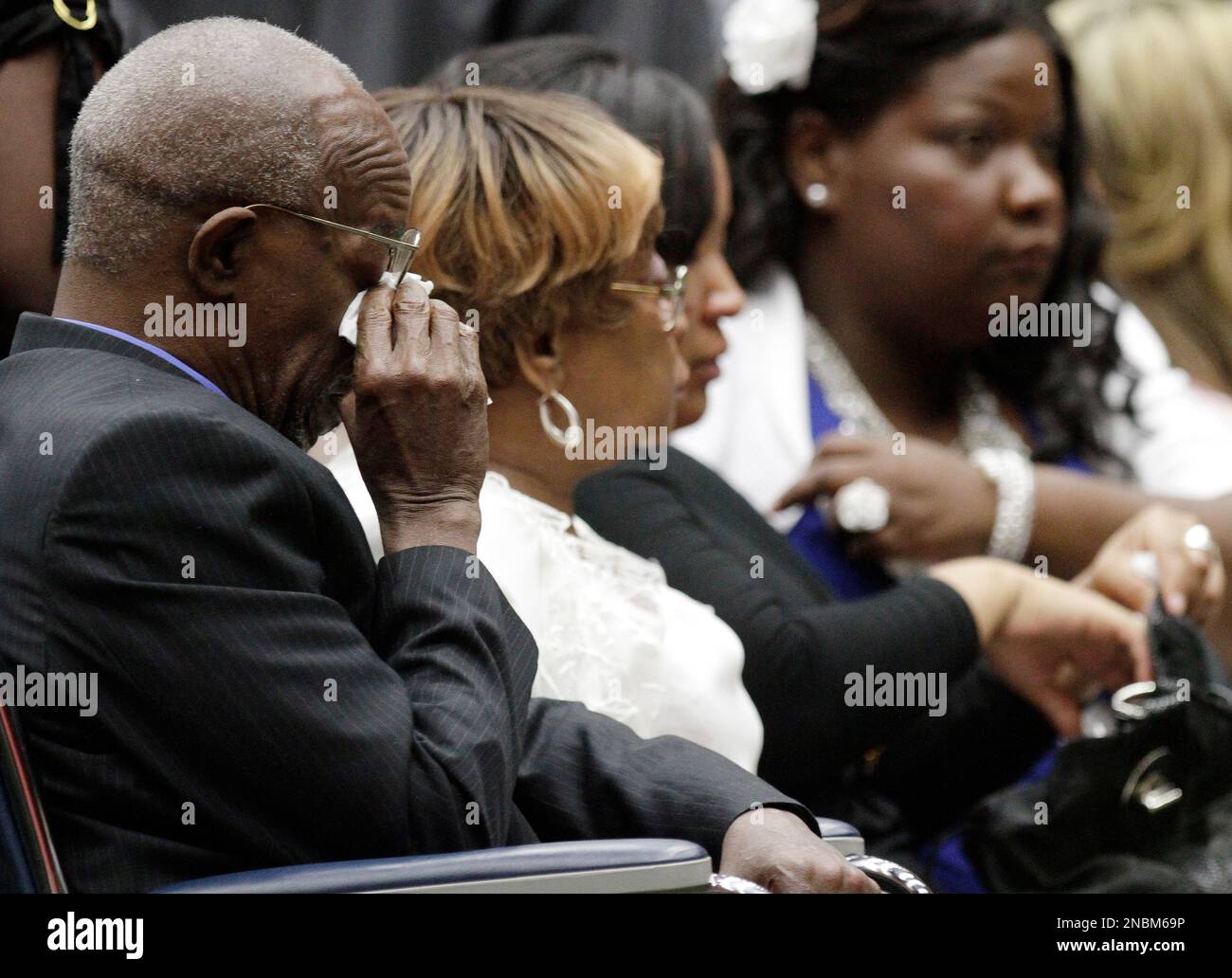 Calvin Luper, left, son of civil rights activist Clara Luper, wipes a ...