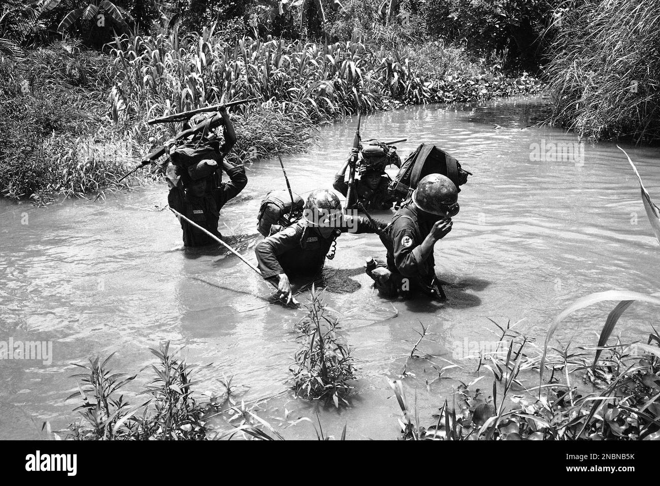 Vietnamese Rangers up to their waists in brown water of a Mekong Delta ...