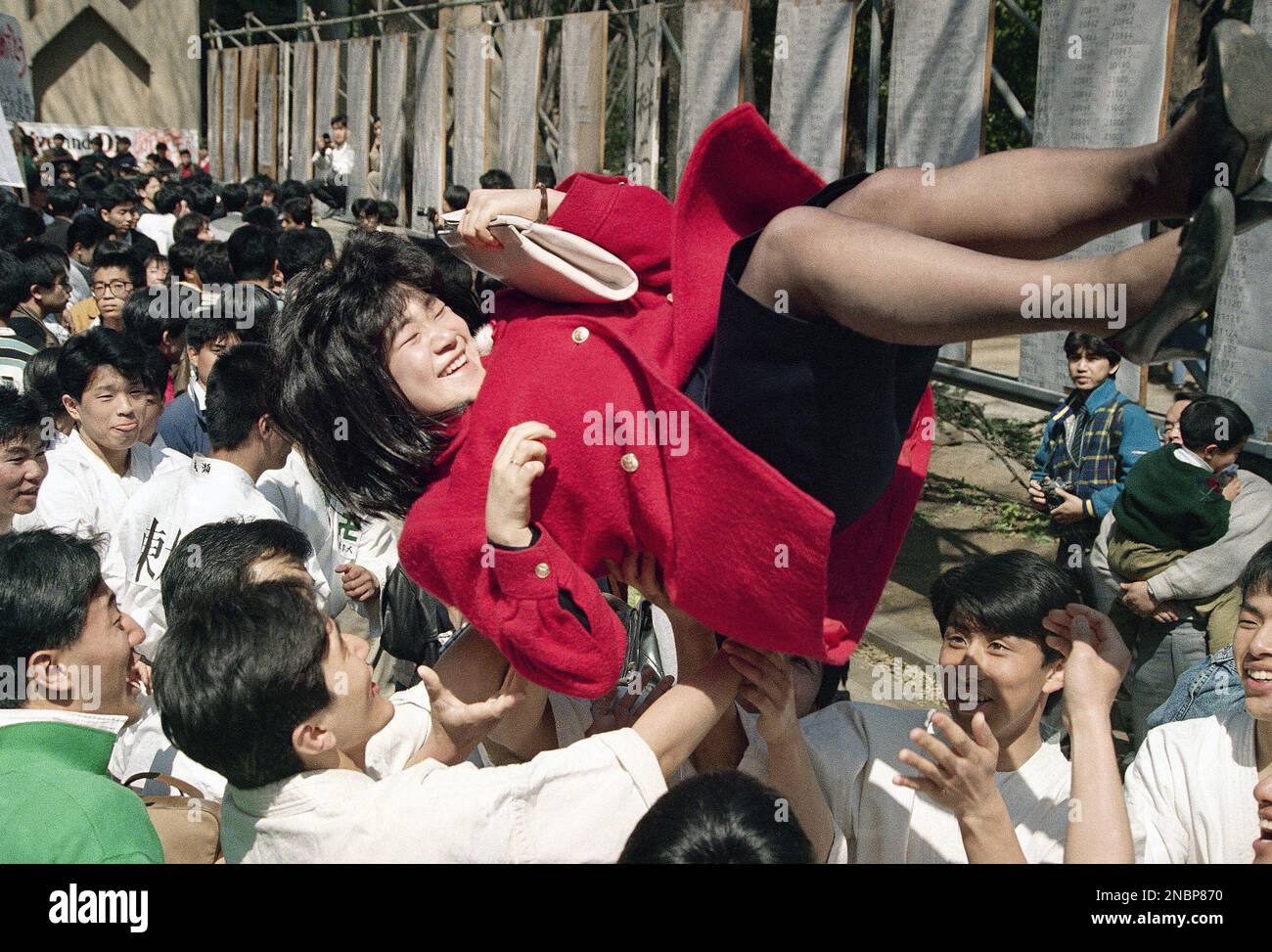 Tokyo University students give a traditional toss-in-air welcome to a ...