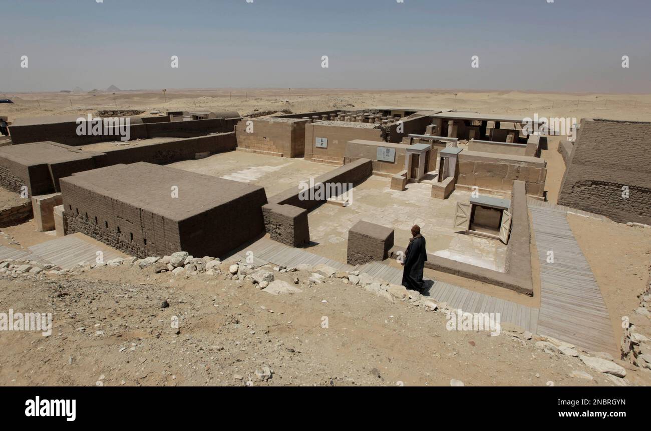 A worker of Egypt's antiquities walks at the site of the New Kingdom ...