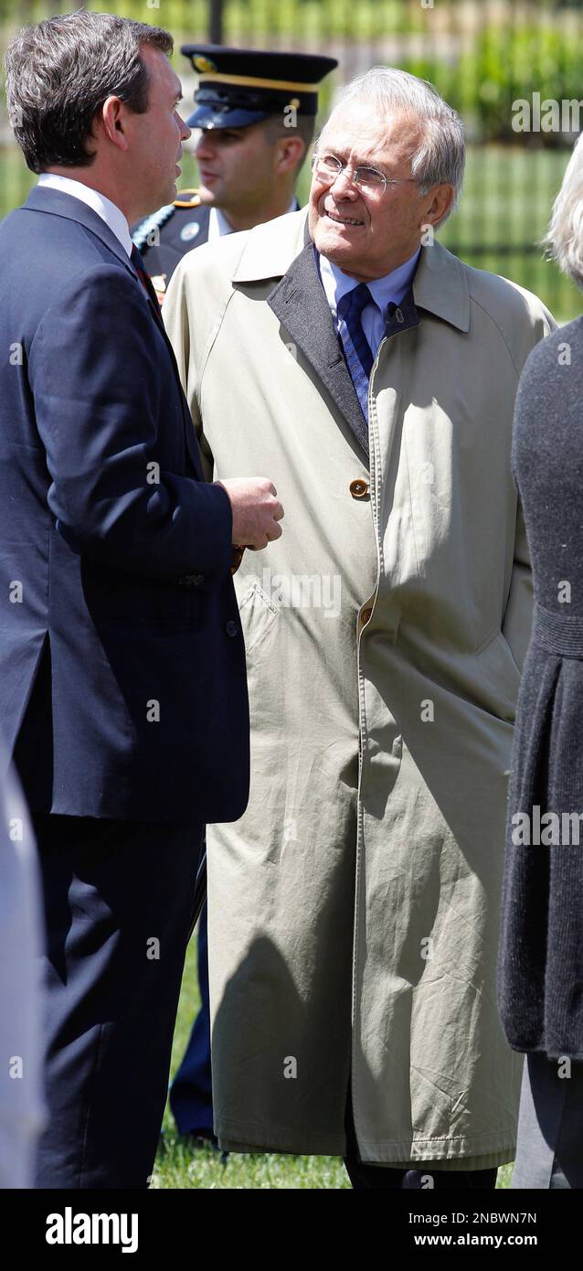 Former Secretary of Defense Donald H. Rumsfeld, right, stands before a ...