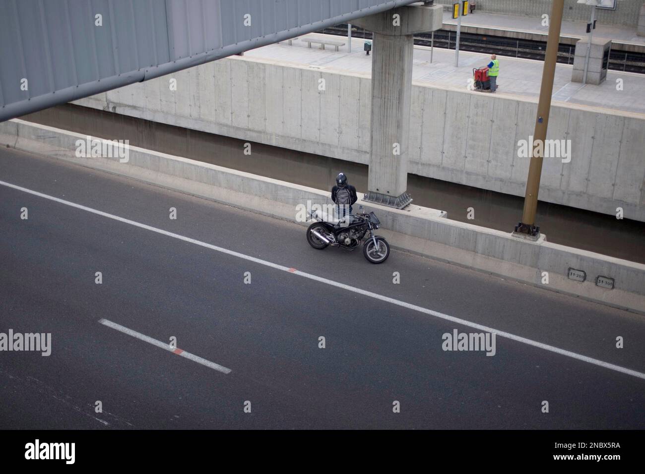 An Israelis motorist stands behind his motorcycle as a siren marking ...