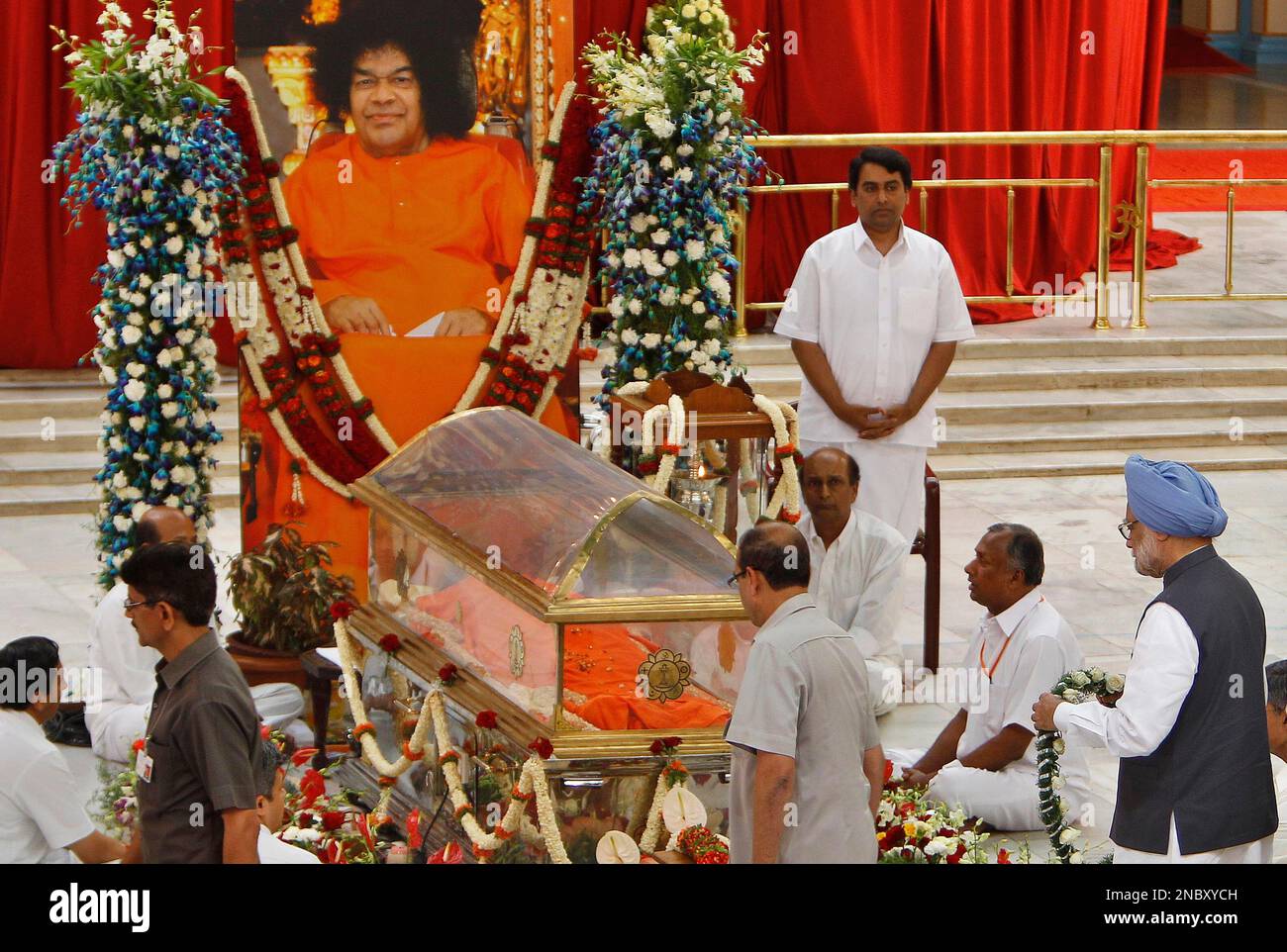 Indian Prime Minister Manmohan Singh, right, offers floral tribute to ...