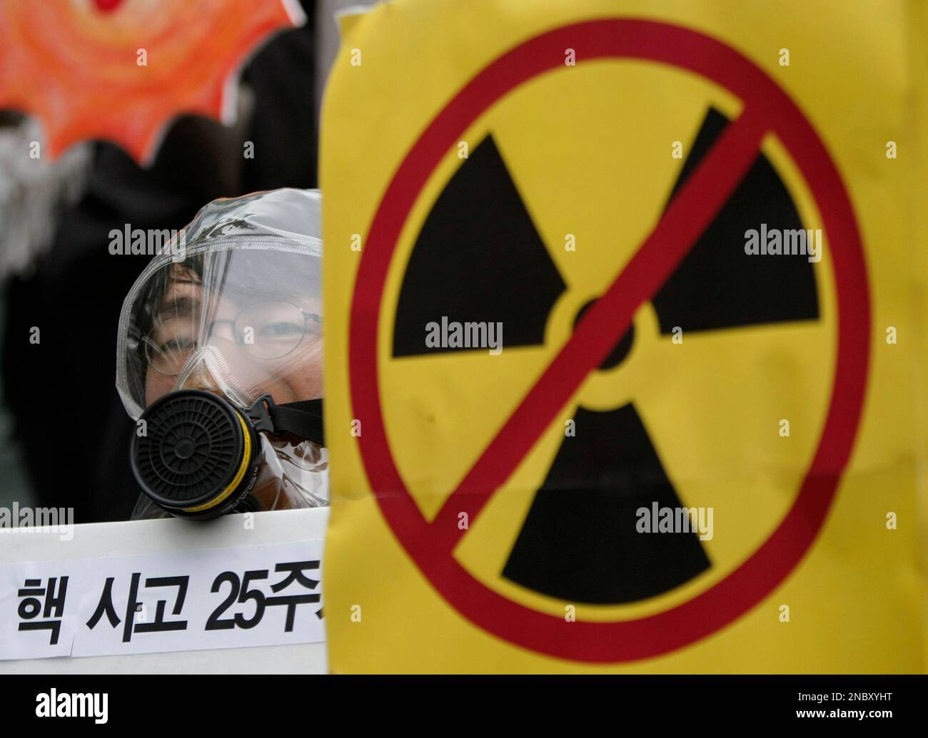 A South Korean environmentalist wearing a gas mask participates in a ...