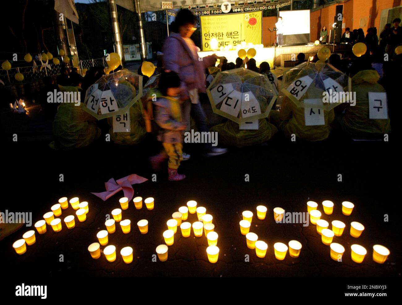 Candles are placed to show their will during a rally to mark the 25th ...