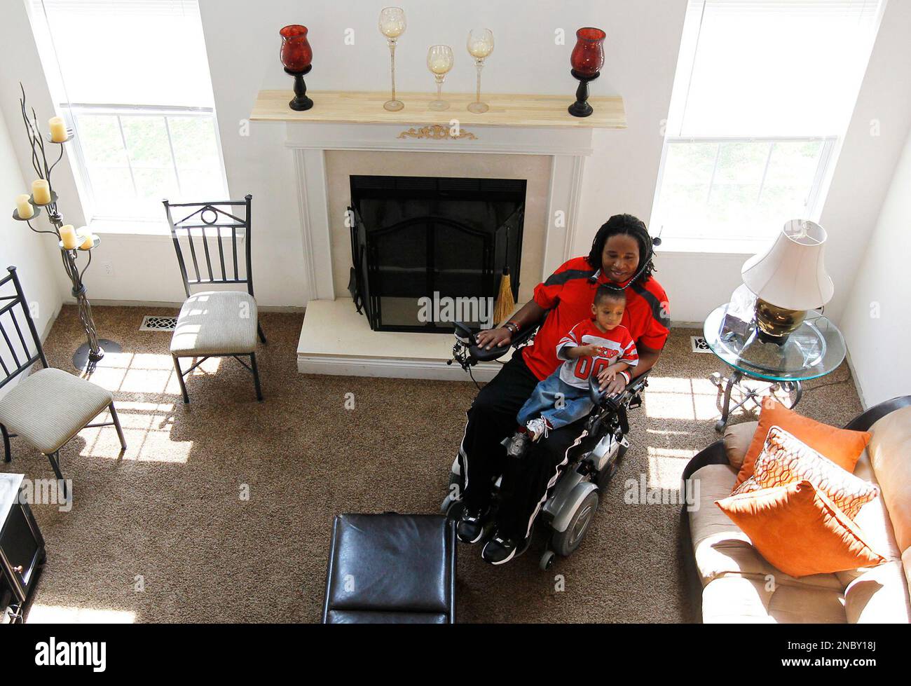 Eric LeGrand carries his 1-year-old nephew Xavier Harrigan while in the ...