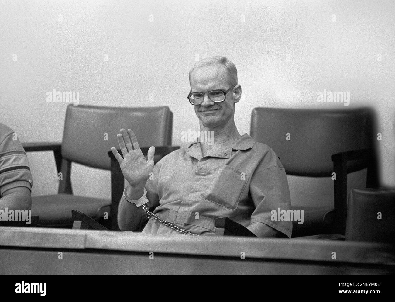 Perry Bernard “Red” Wartham, a neo-Nazi leader, smiles and waves to photographers during an ...