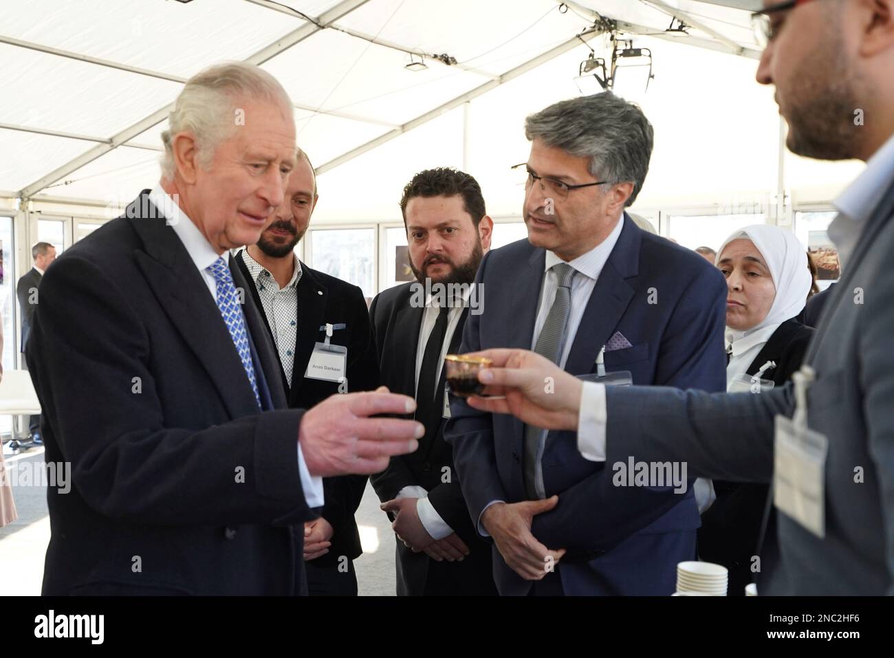 King Charles III is given Syrian tea as he talks with members of the ...