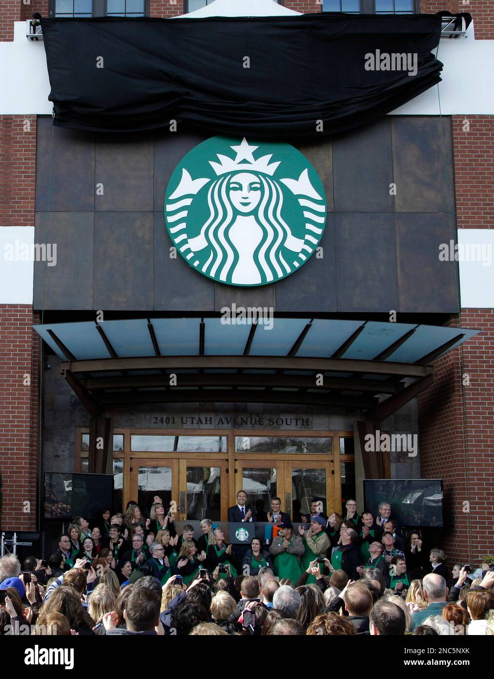 Starbucks Corp. CEO Howard Schultz, lower center, unveils the company's ...