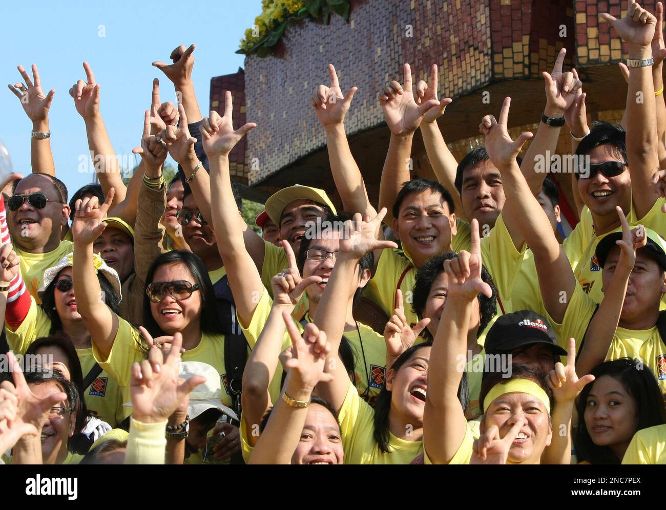 Filipinos flash the "L" sign (for laban, meaning fight) following the ...