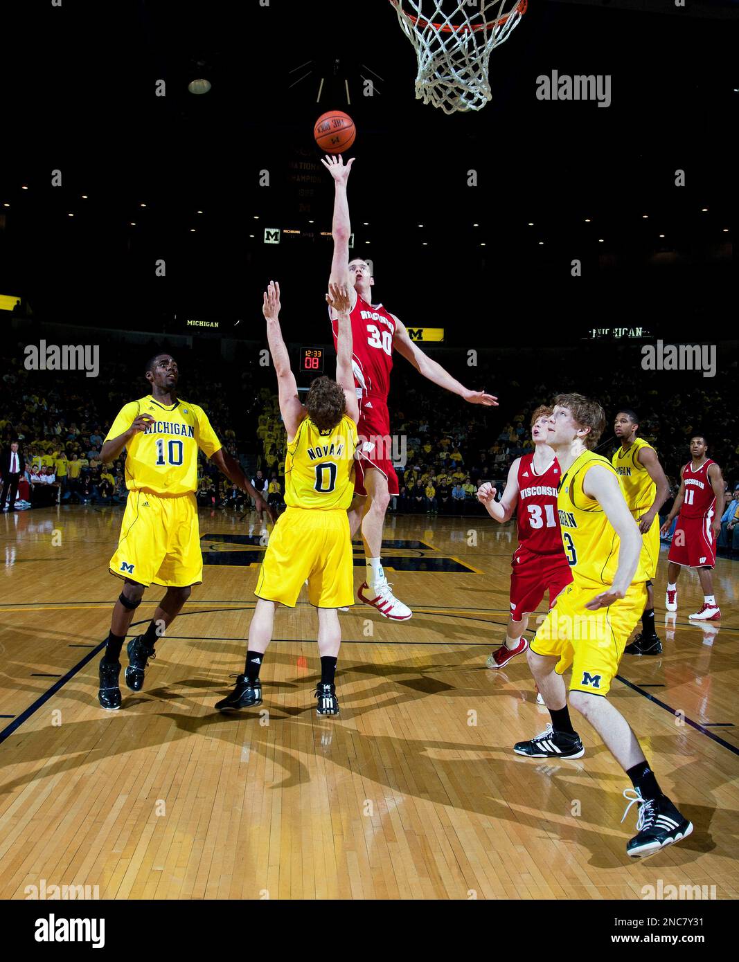 Wisconsin forward Jon Leuer (30) shoots over Michigan guard Zack Novak ...
